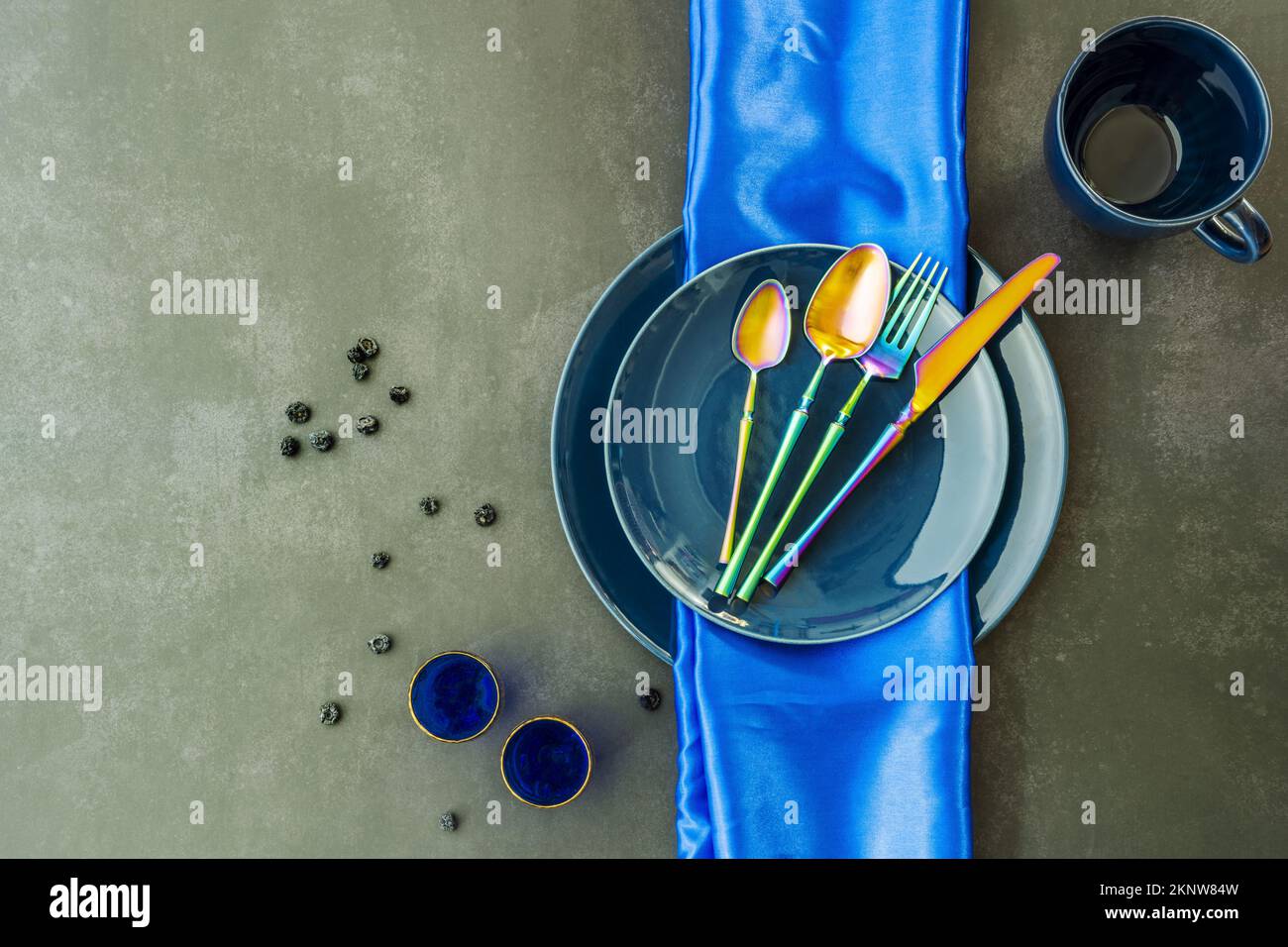 Top view image of various blue porcelain plates with blue tablecloth ...