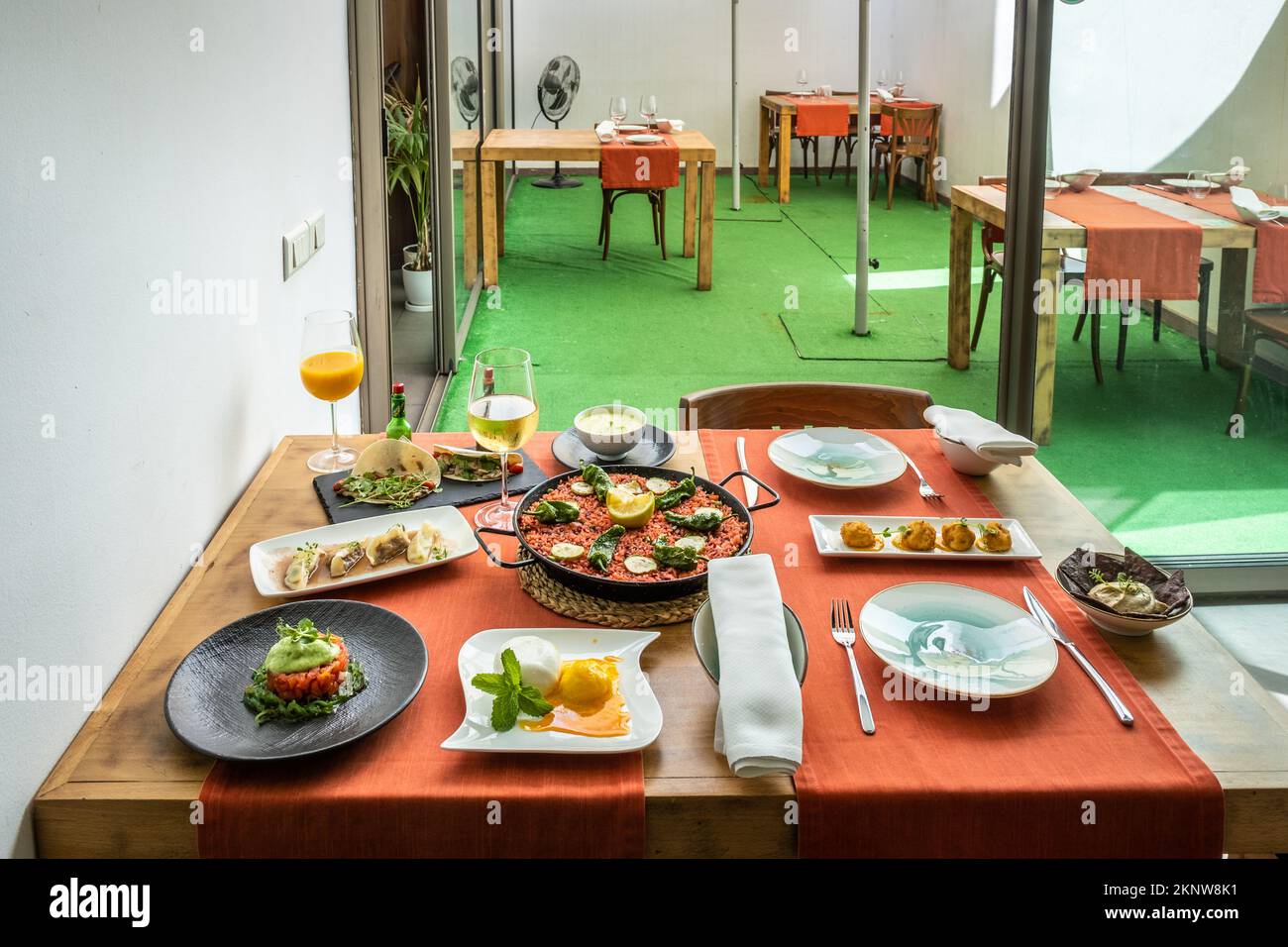 A laid table with various Spanish and Mexican cuisine dishes in the ...