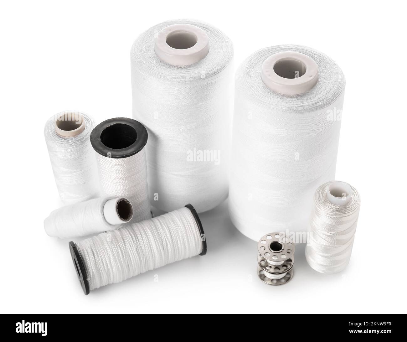 Different thread spools isolated on white background Stock Photo - Alamy