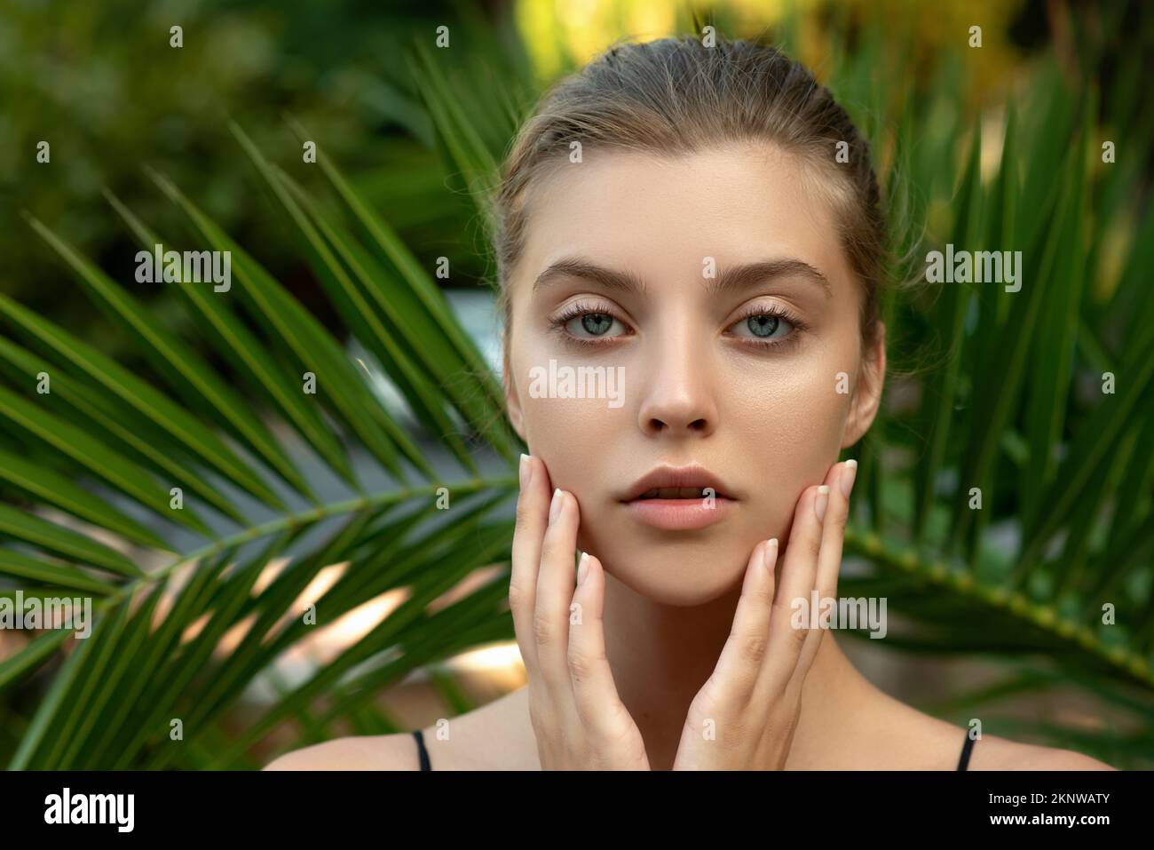 Beautiful Young Woman With Clean Perfect Skin In Tropical Green Leaves