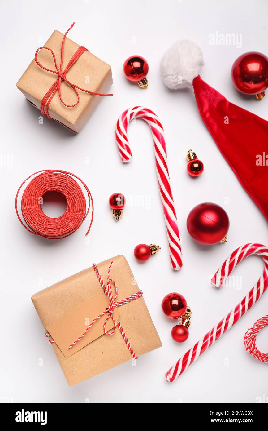 Composition with Christmas gifts, candy canes and balls on light ...
