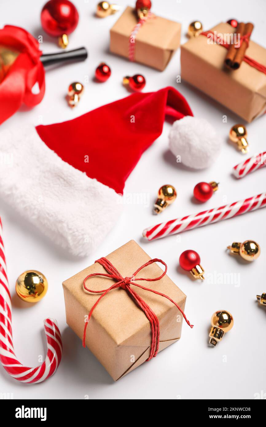 Composition with Santa hat, Christmas gifts, balls and candy canes on ...