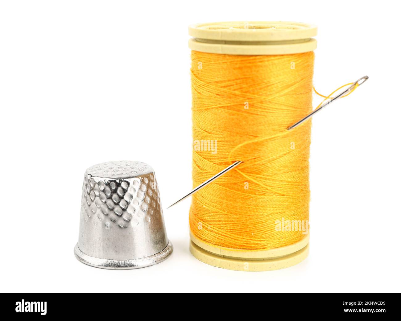 Thread spool with needle and thimble on white background Stock Photo ...