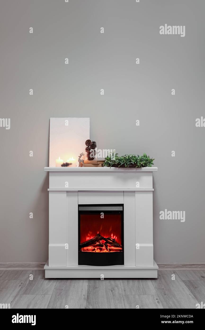 Blank poster with candles, Christmas wreath, fir cones and books on ...