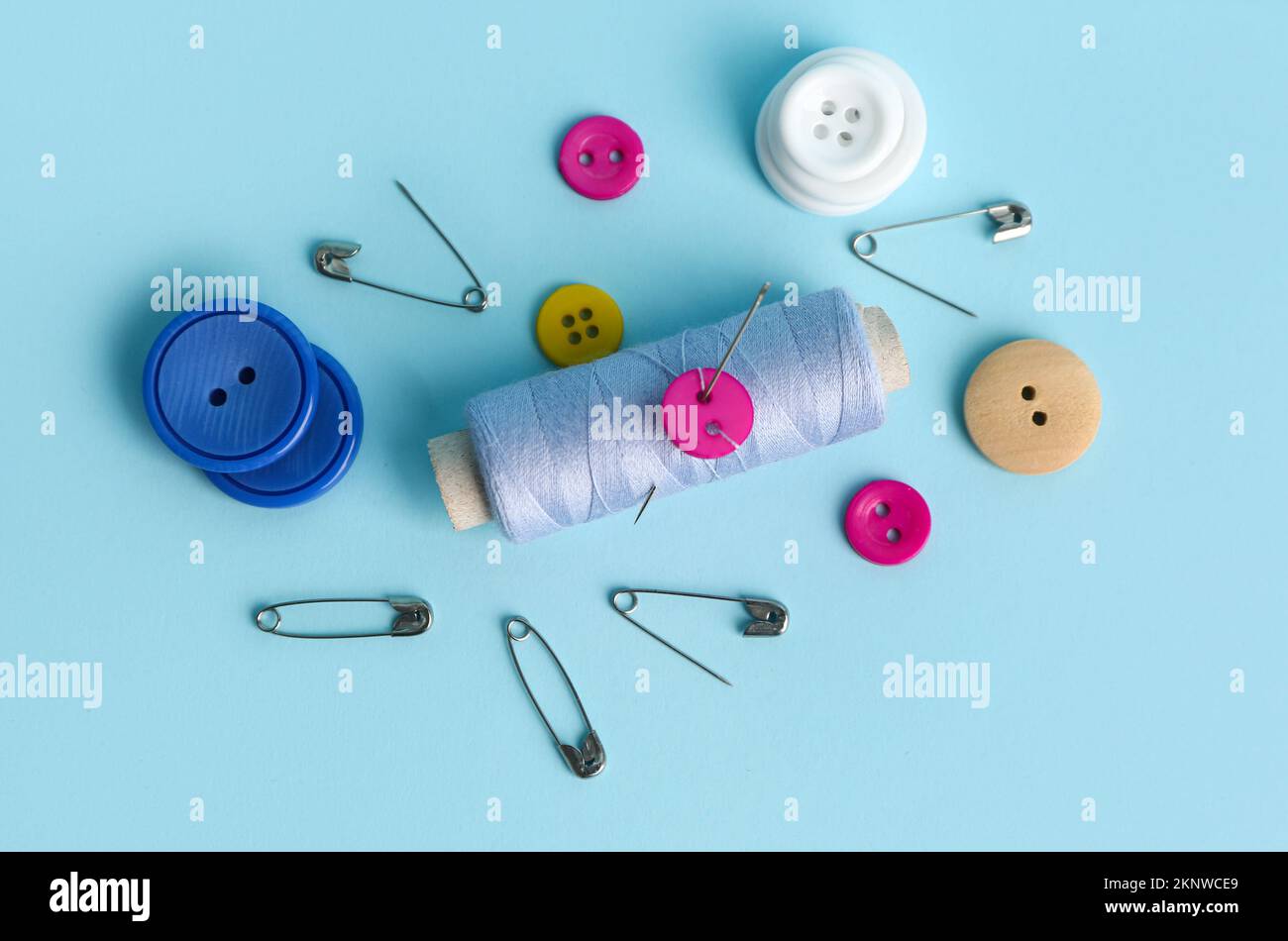 Set of sewing supplies with thread spool on color background Stock ...