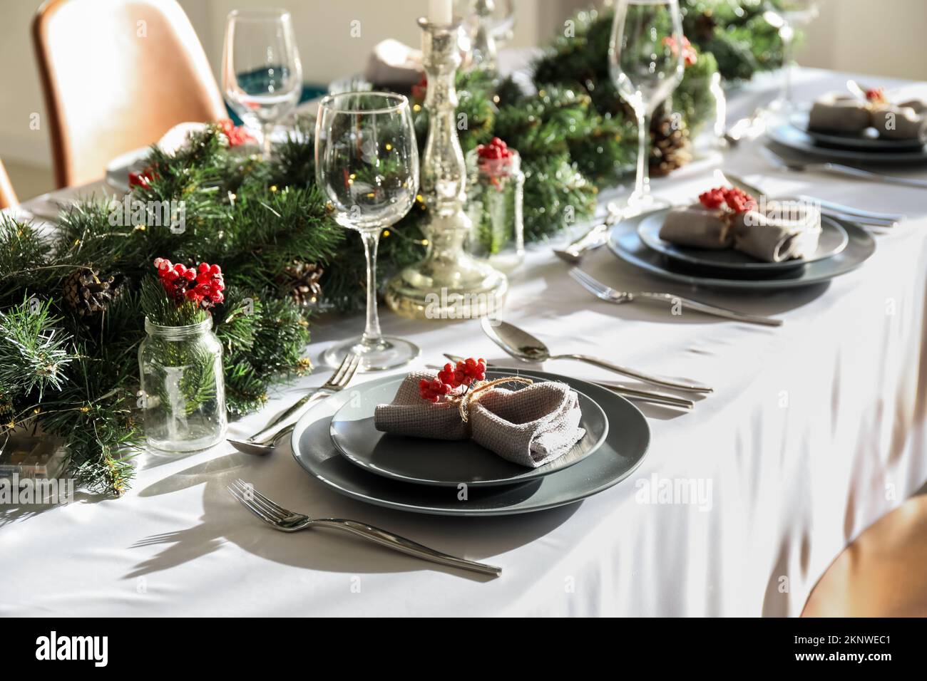 Christmas table setting with fir branches and rowan in dining room Stock Photo - Alamy