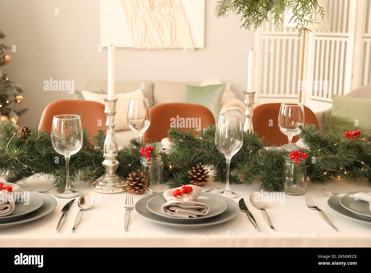 Christmas table setting with fir branches and rowan in dining room Stock Photo - Alamy