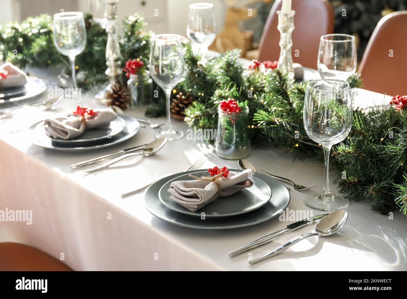 Christmas table setting with fir branches and rowan in dining room Stock Photo - Alamy