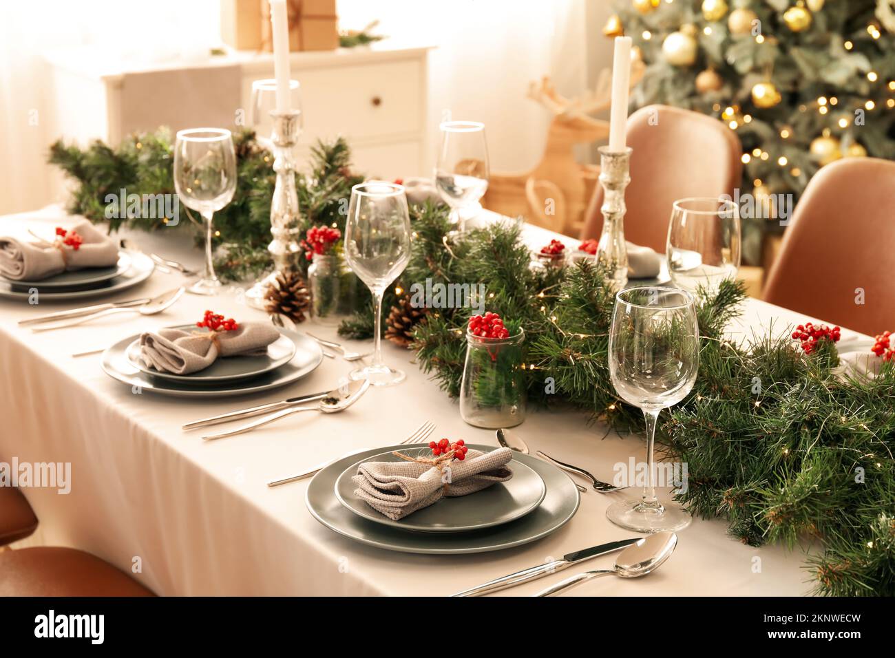 Christmas table setting with fir branches and rowan in dining room Stock Photo - Alamy