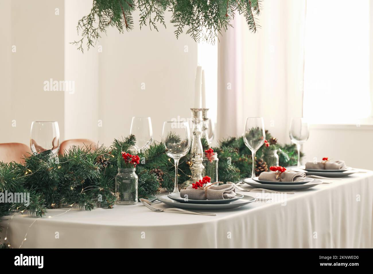 Christmas table setting with fir branches and rowan in dining room Stock Photo - Alamy