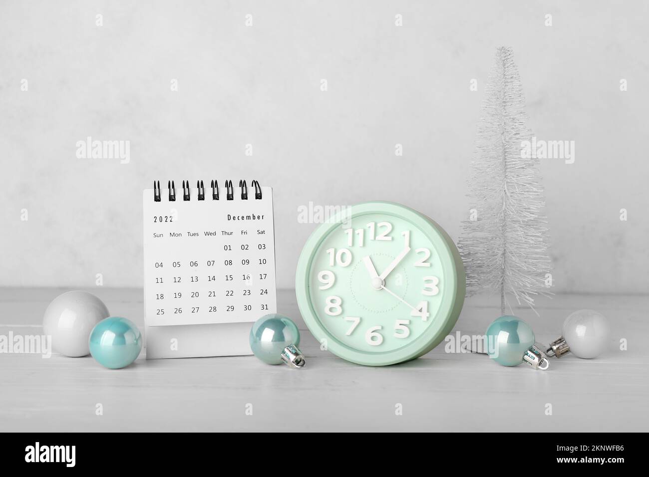Flip calendar for December 2022 with Christmas balls and alarm clock on ...