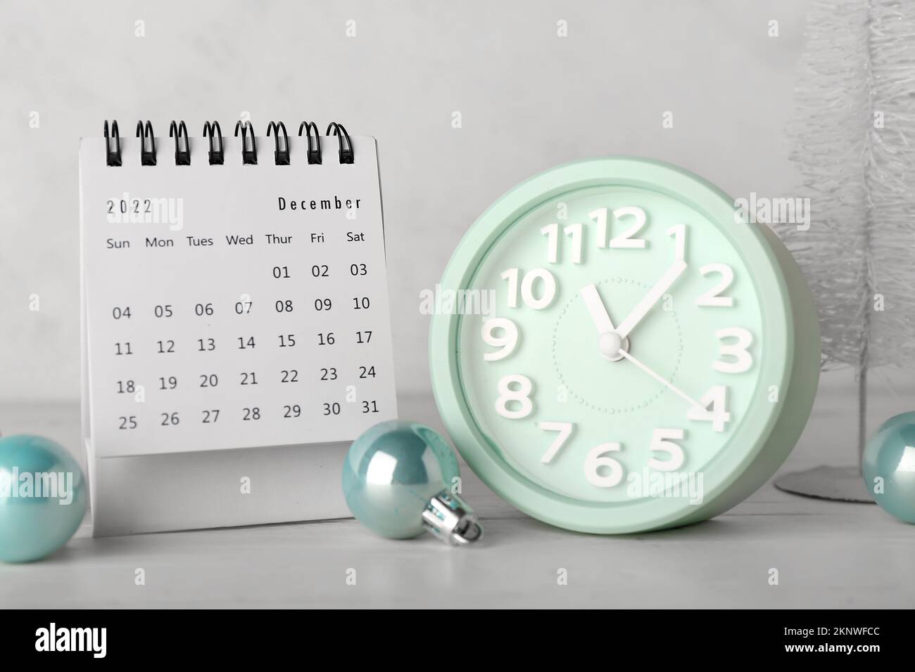 Flip calendar for December 2022 with Christmas balls and alarm clock on ...