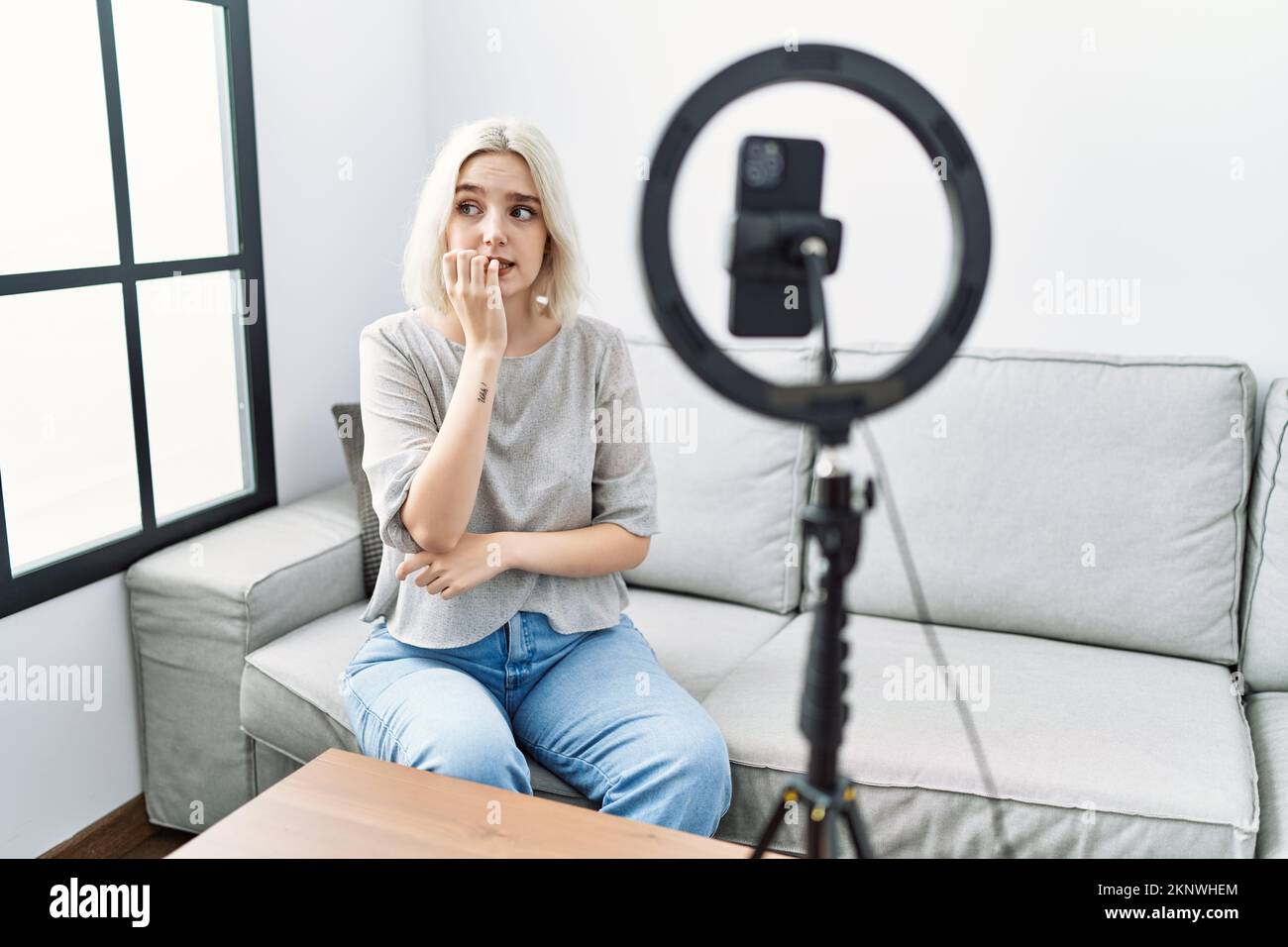 Young caucasian woman recording vlog tutorial with smartphone at home ...