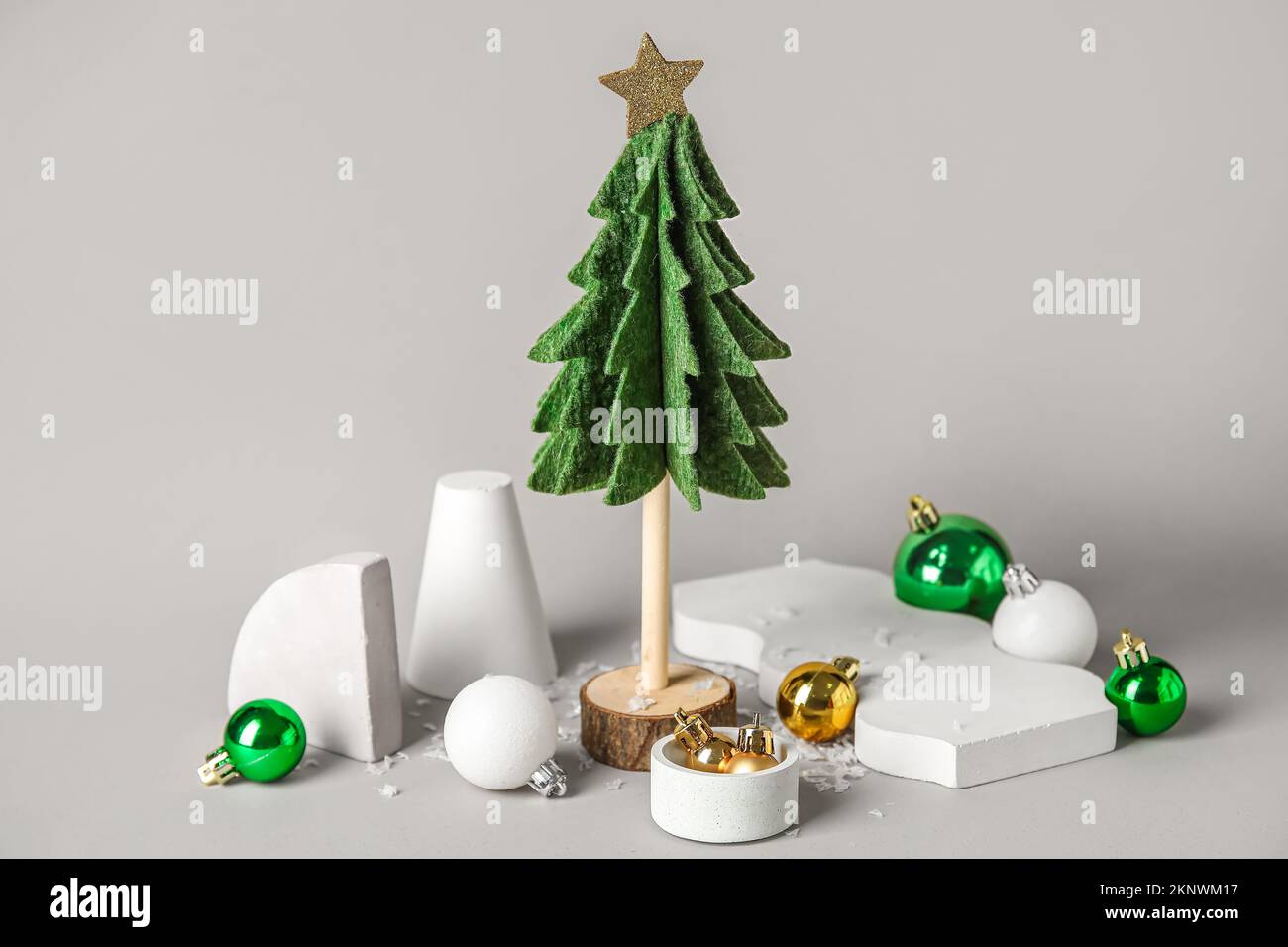 Decorative Christmas tree with podiums and balls on grey background ...