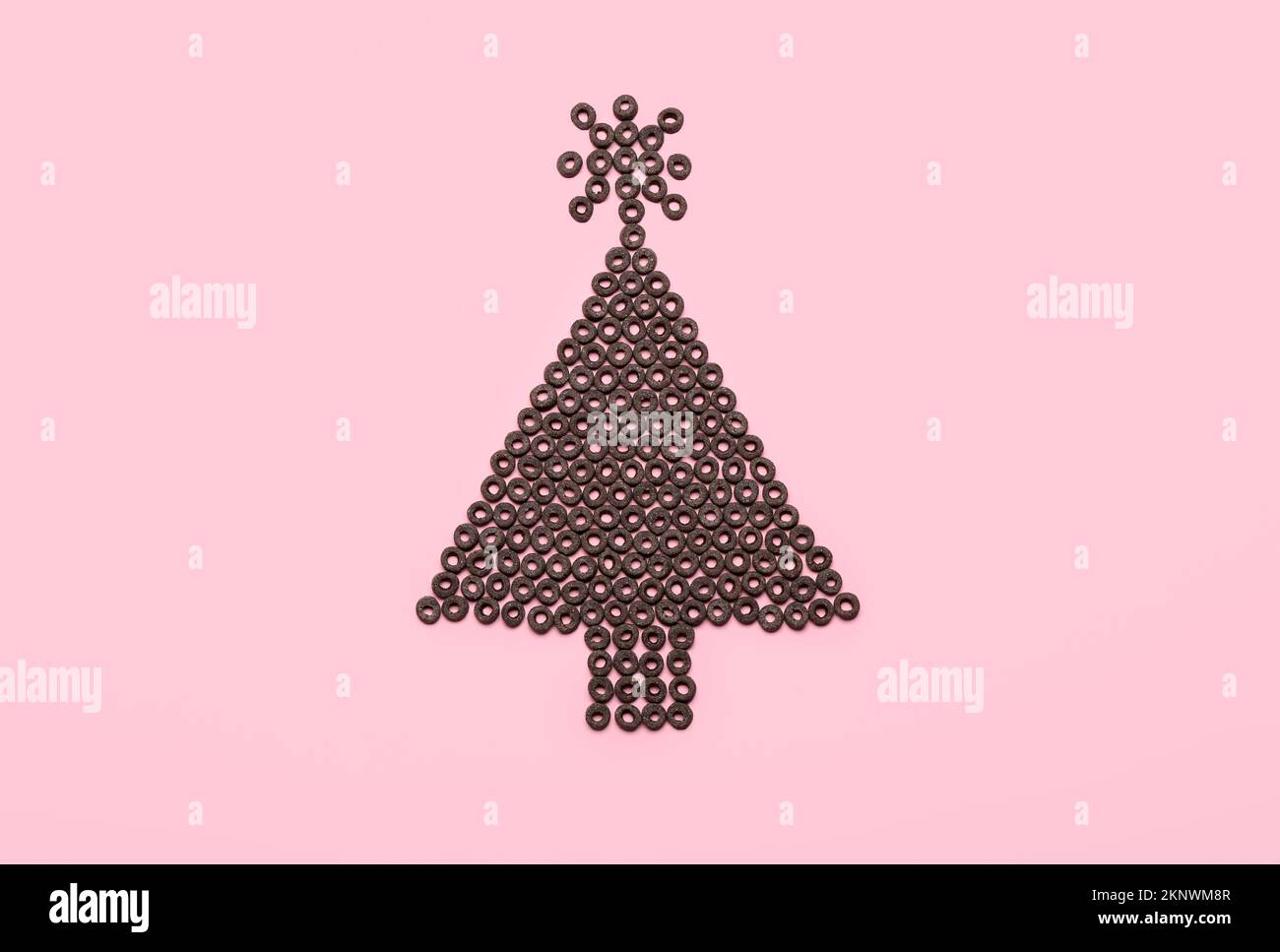 Christmas tree made of cereal rings on pink background Stock Photo - Alamy