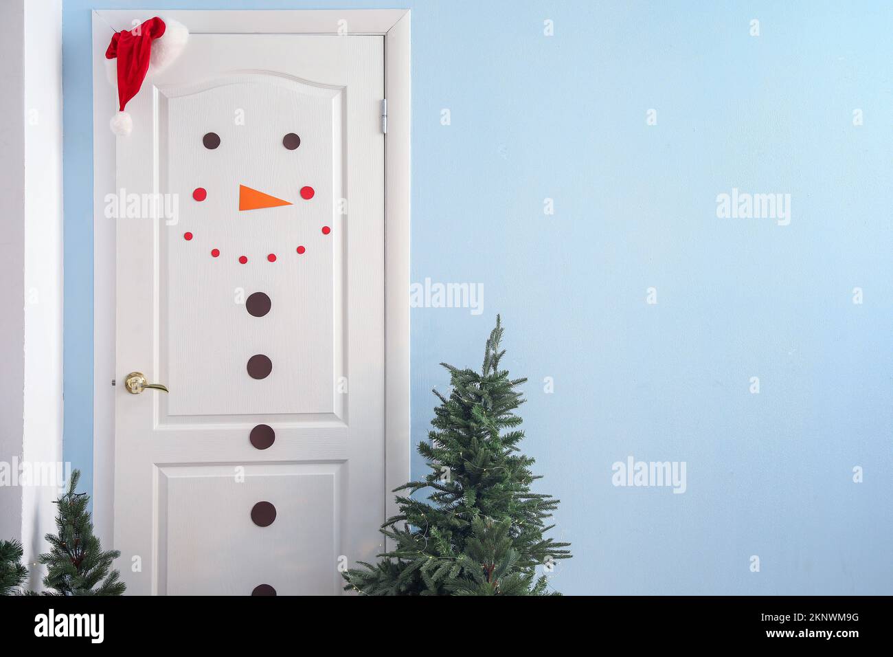 White door with snowman and Christmas trees in hall Stock Photo - Alamy