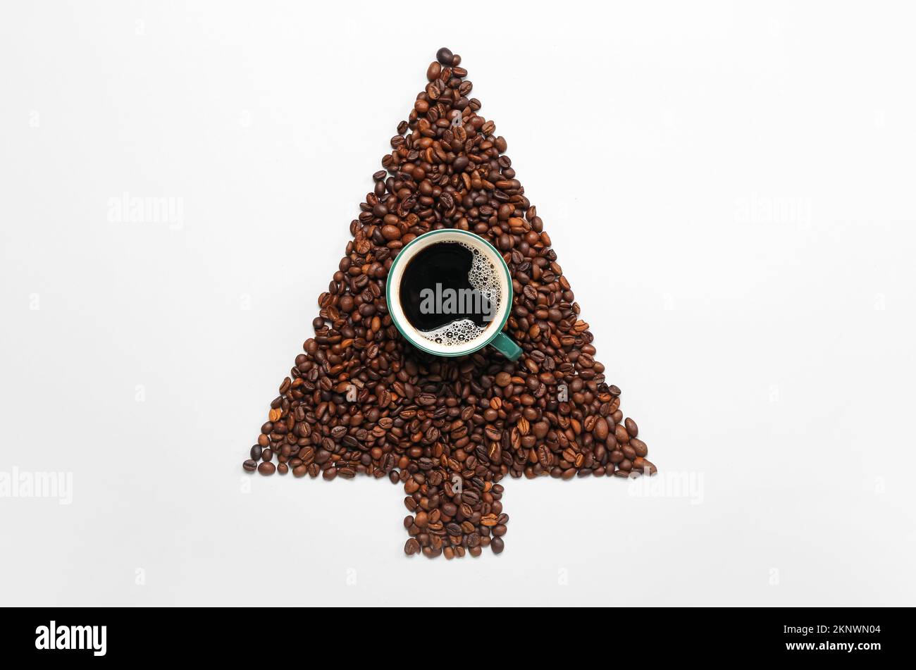 Christmas tree made of coffee cup and beans on light background Stock ...