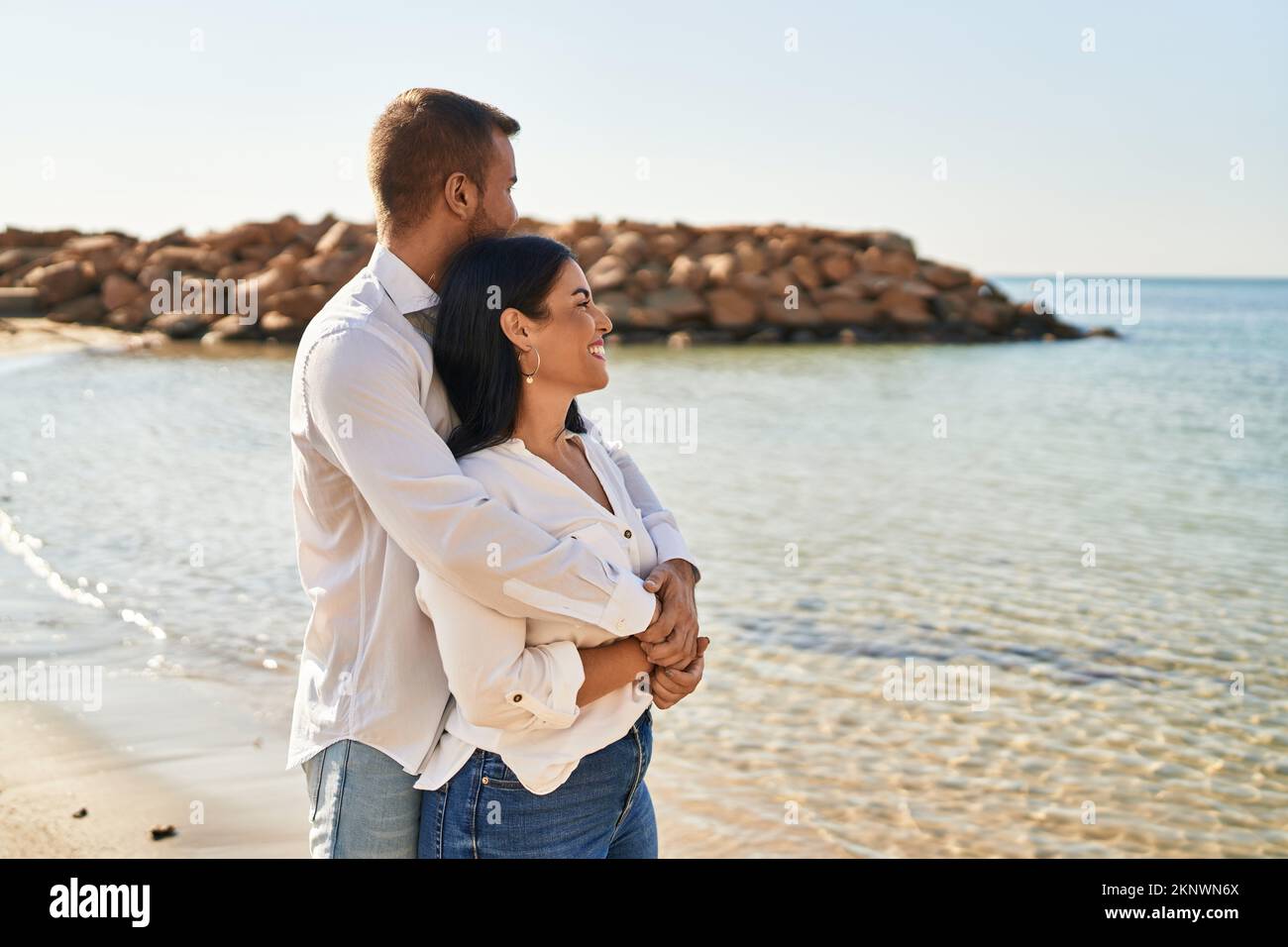 Man and woman couple smiling happy hugging each other standing at ...