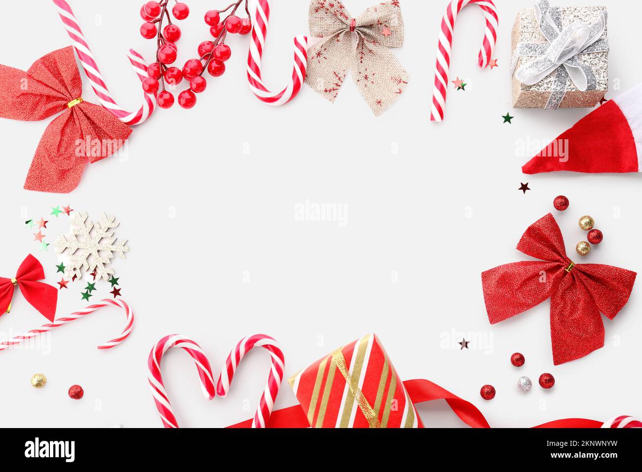 Frame made of Christmas decorations and candy canes on white background ...