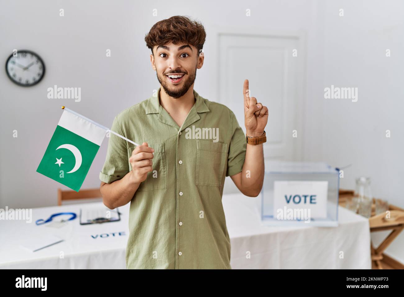 Young arab man at political campaign election holding pakistan flag ...
