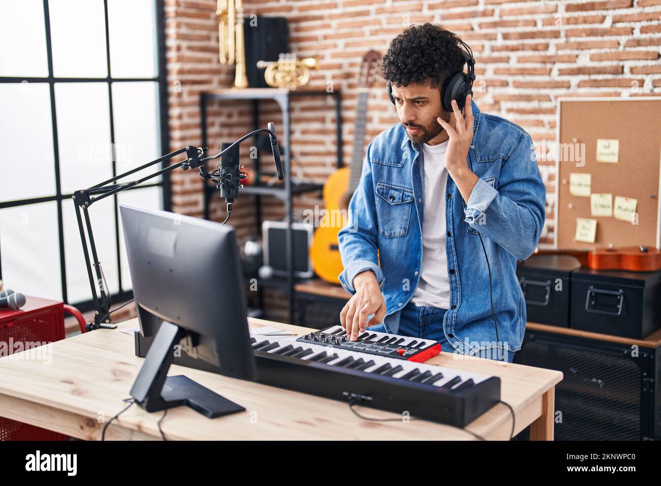 Young arab man musician playing piano keyboard at music studio Stock ...