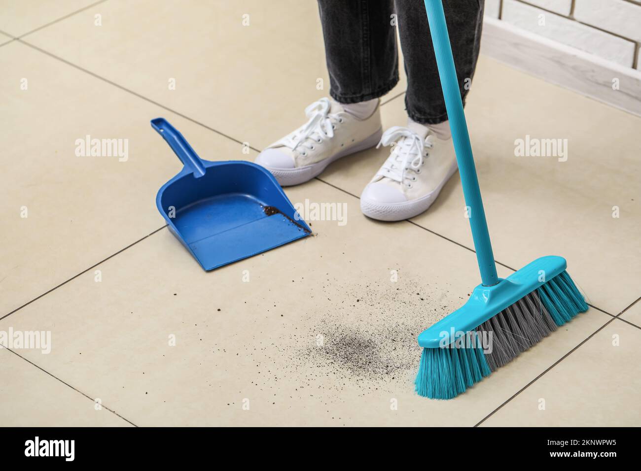 Woman sweeping light tile floor with broom and dustpan Stock Photo - Alamy