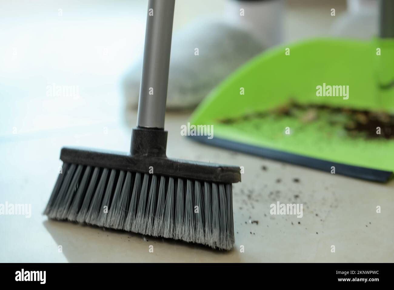 Cleaning broom on tile floor, closeup Stock Photo - Alamy