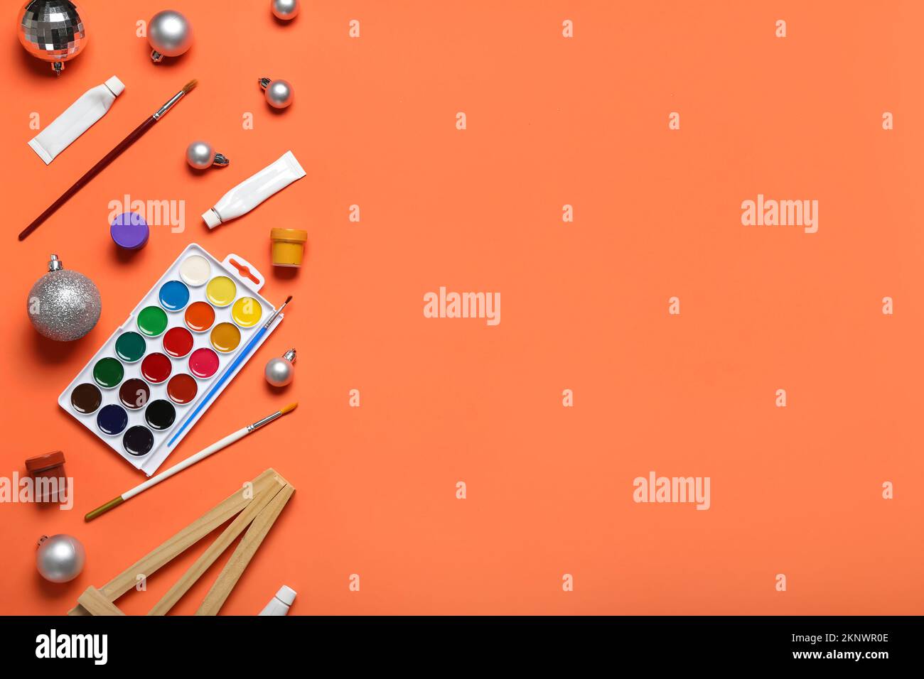 Painter tools with Christmas balls on red background Stock Photo - Alamy