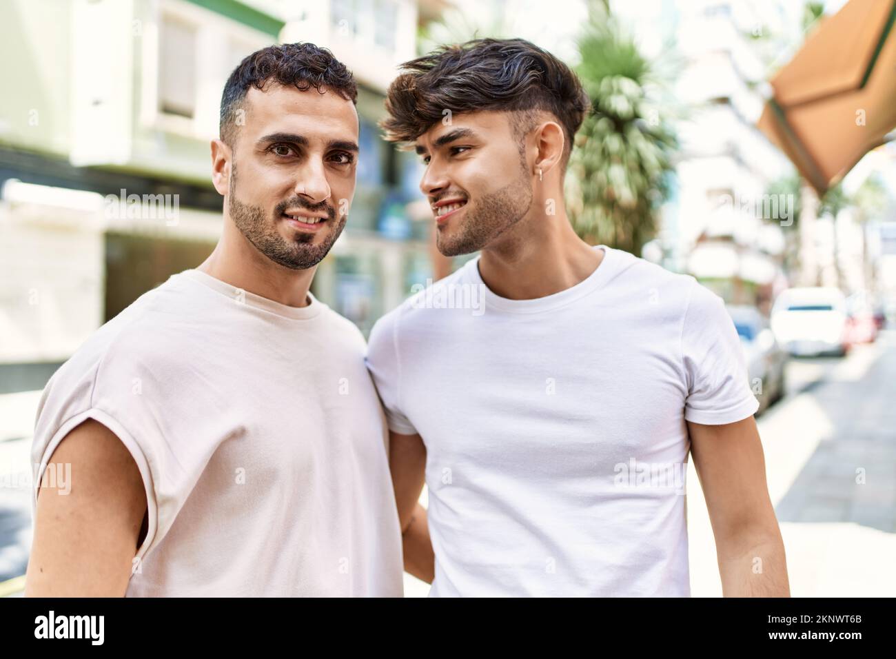 Two hispanic men couple smiling confident hugging each other standing ...