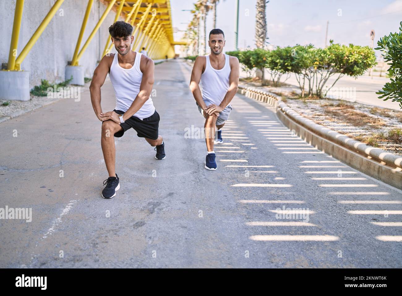 Two hispanic men couple smiling confident stretching at street Stock ...