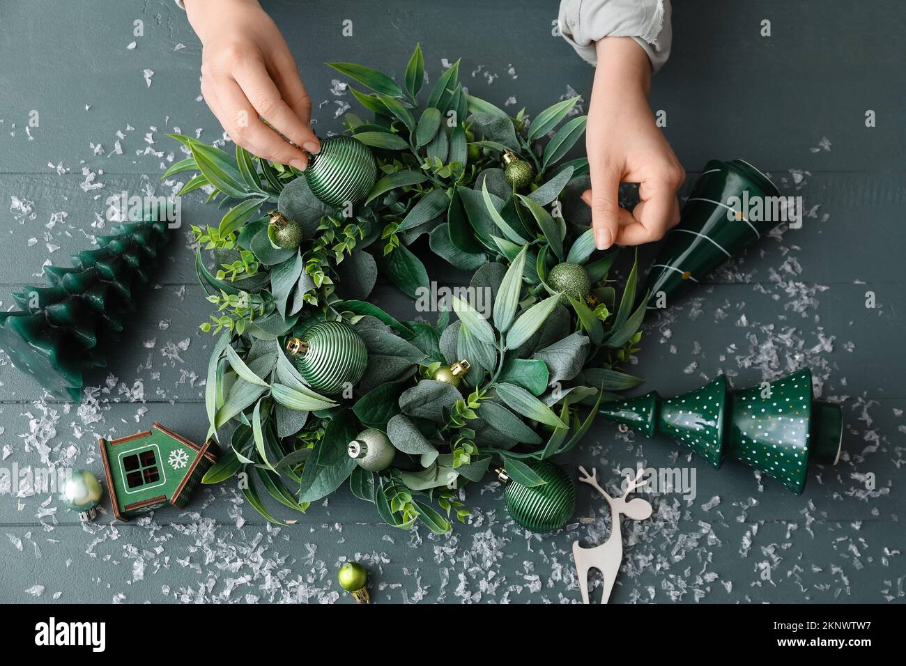 Woman making stylish Christmas wreath color wooden background Stock ...