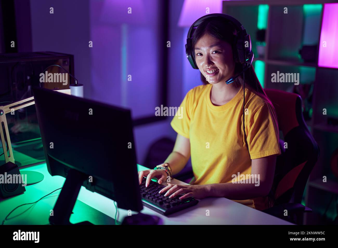 Chinese woman streamer smiling confident using computer at gaming room ...