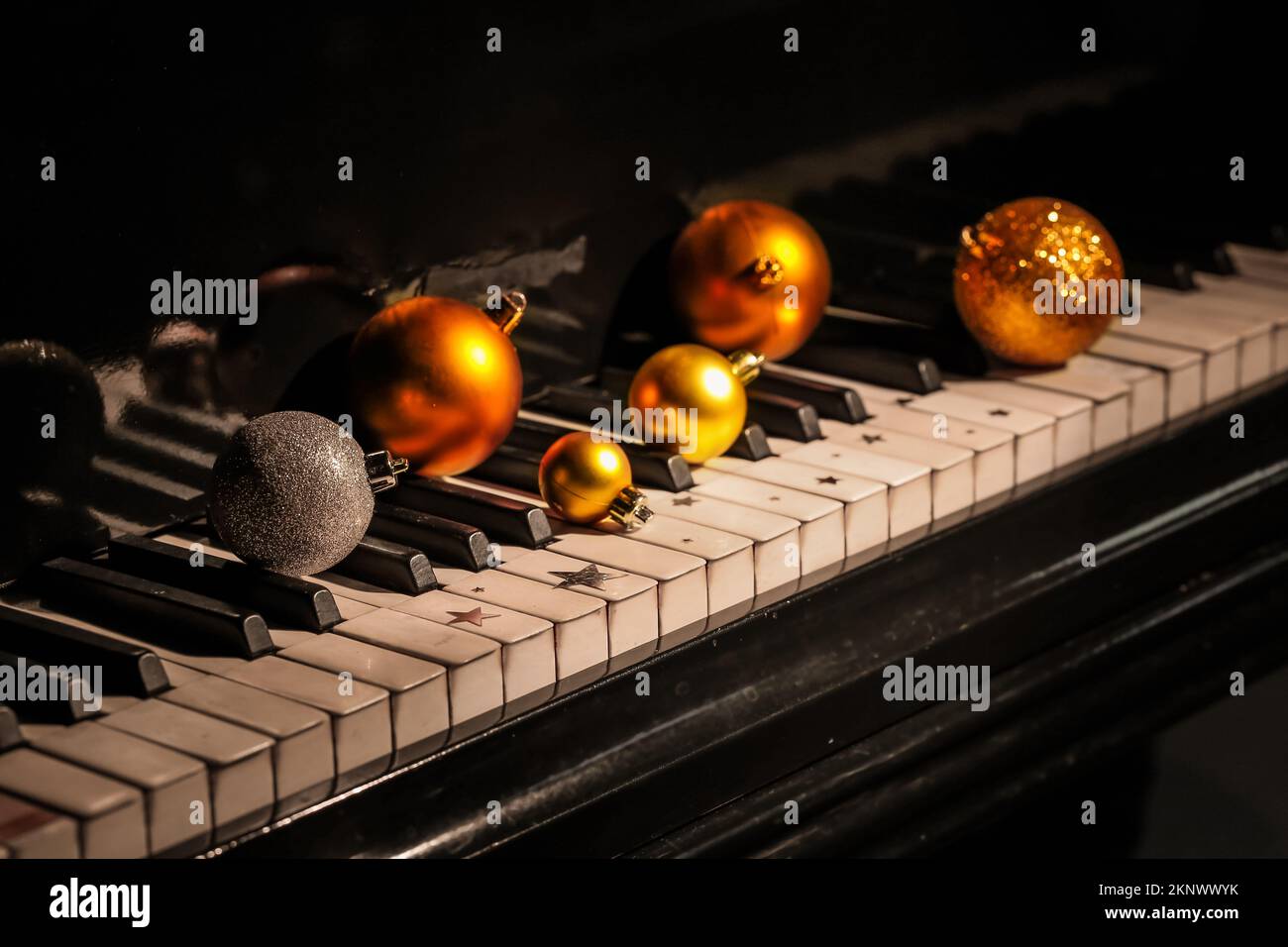 Christmas balls with stars on piano keys at night, closeup Stock Photo ...