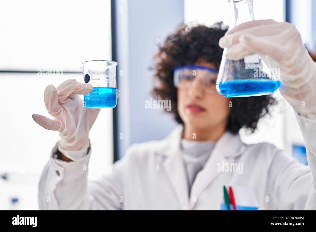 Young middle east woman scientist measuring liquid at laboratory Stock ...