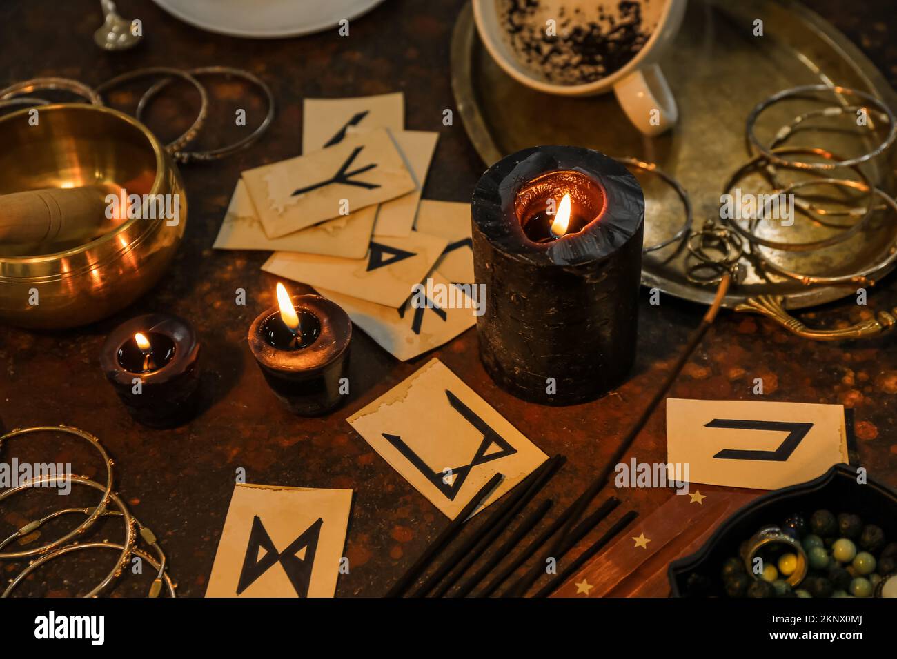 Magic attributes of fortune teller, runes and candles on table Stock ...