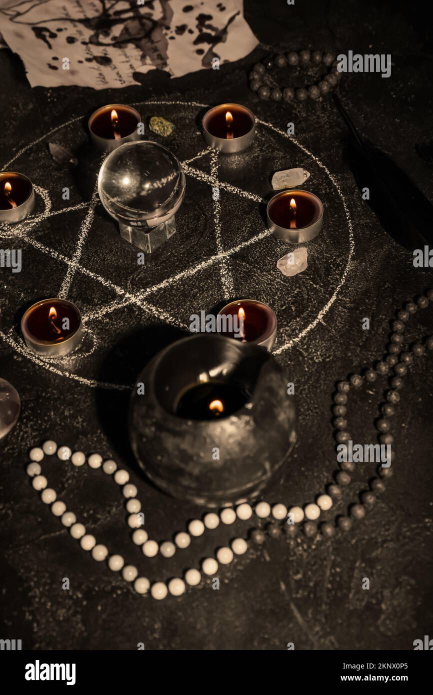 Magic attributes for ritual on dark table Stock Photo - Alamy