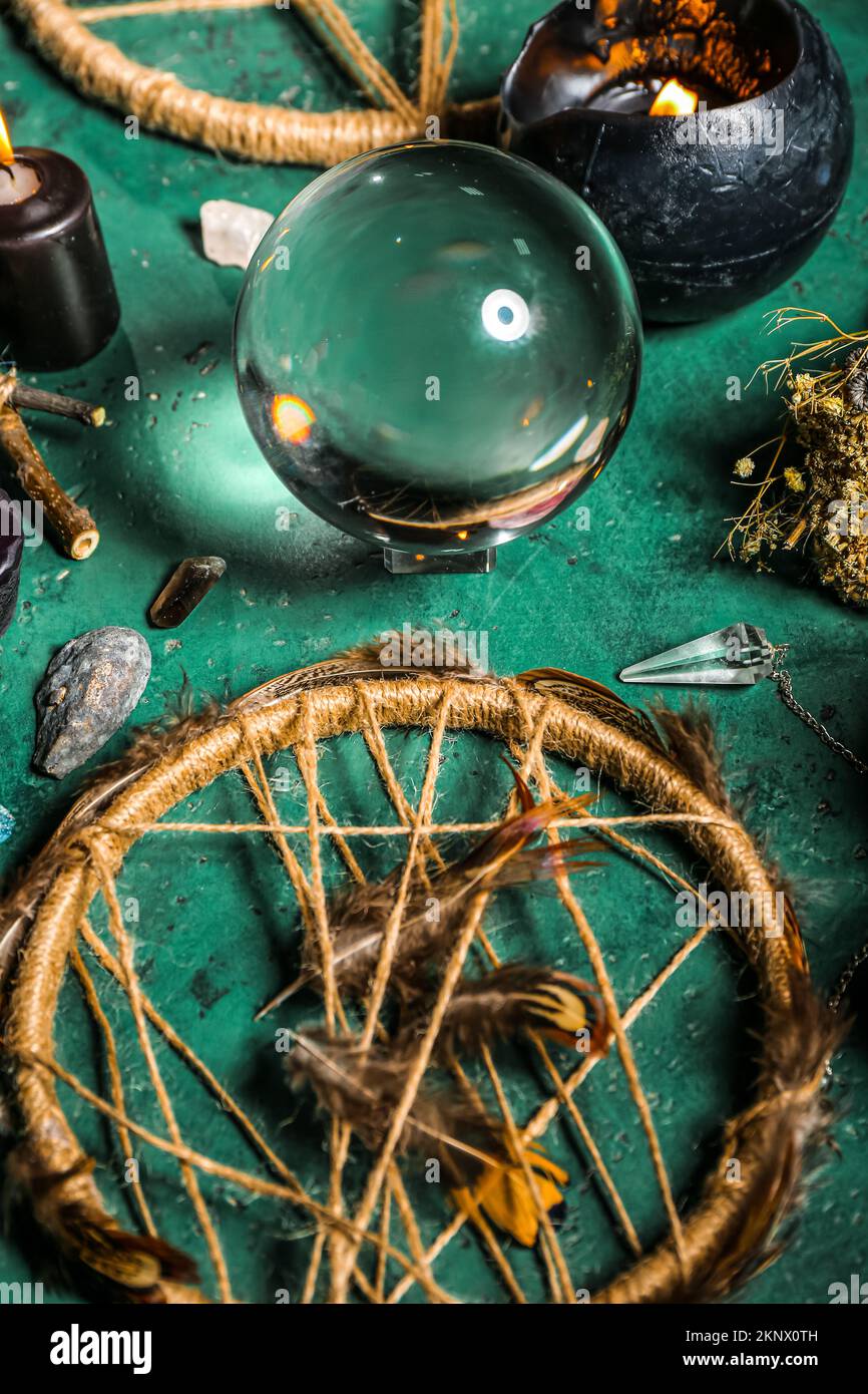 Magic attributes of fortune teller on green table Stock Photo - Alamy