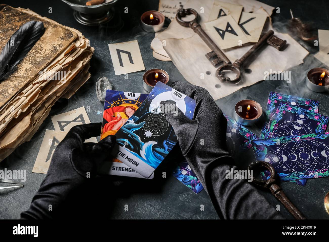 Fortune teller using tarot cards to predict future at table Stock Photo ...