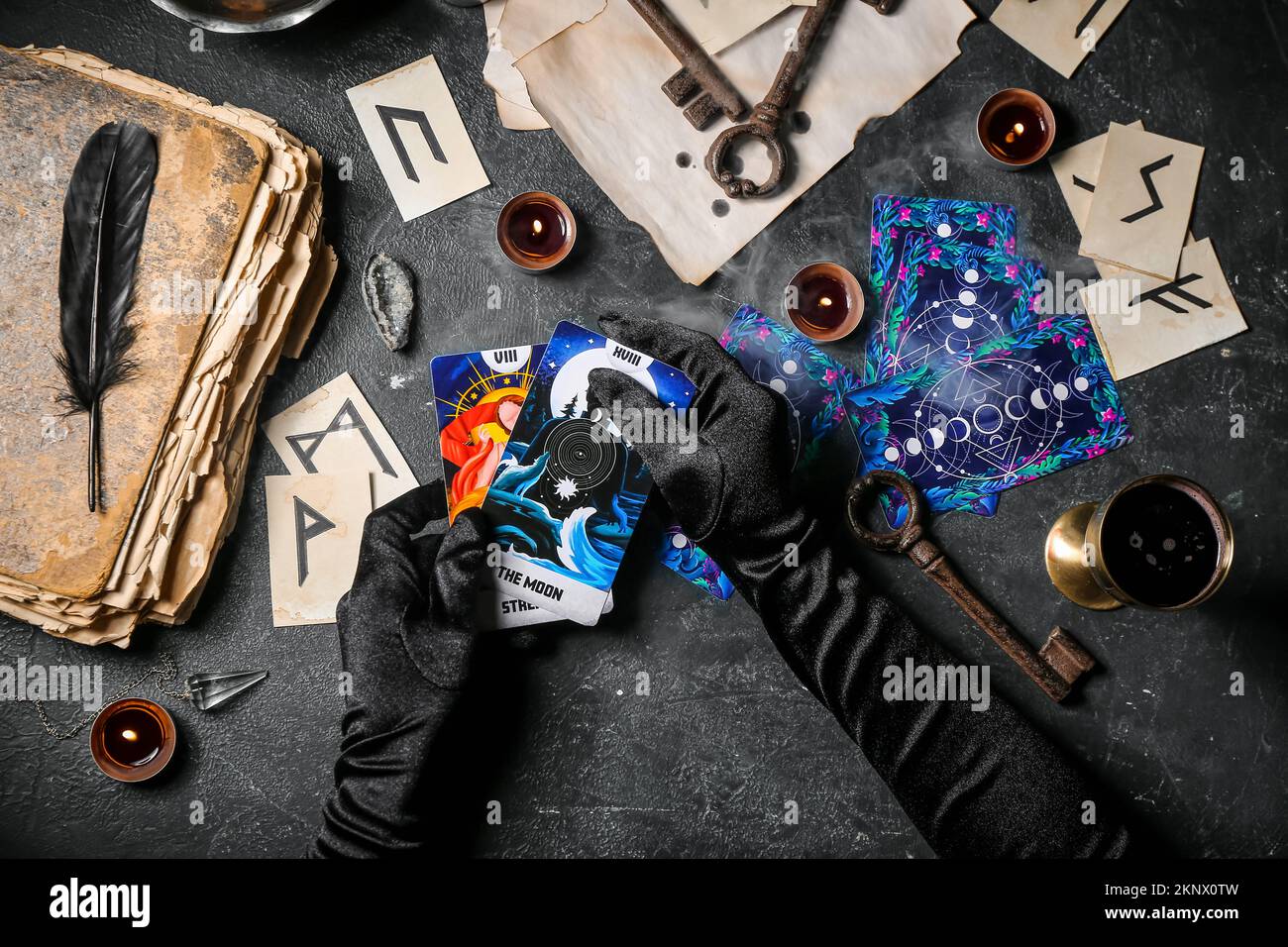 Fortune teller using tarot cards to predict future at table, top view ...
