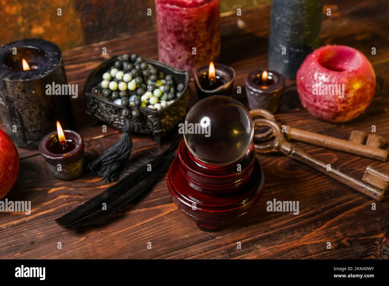 Crystal ball and magic attributes of fortune teller on wooden table ...