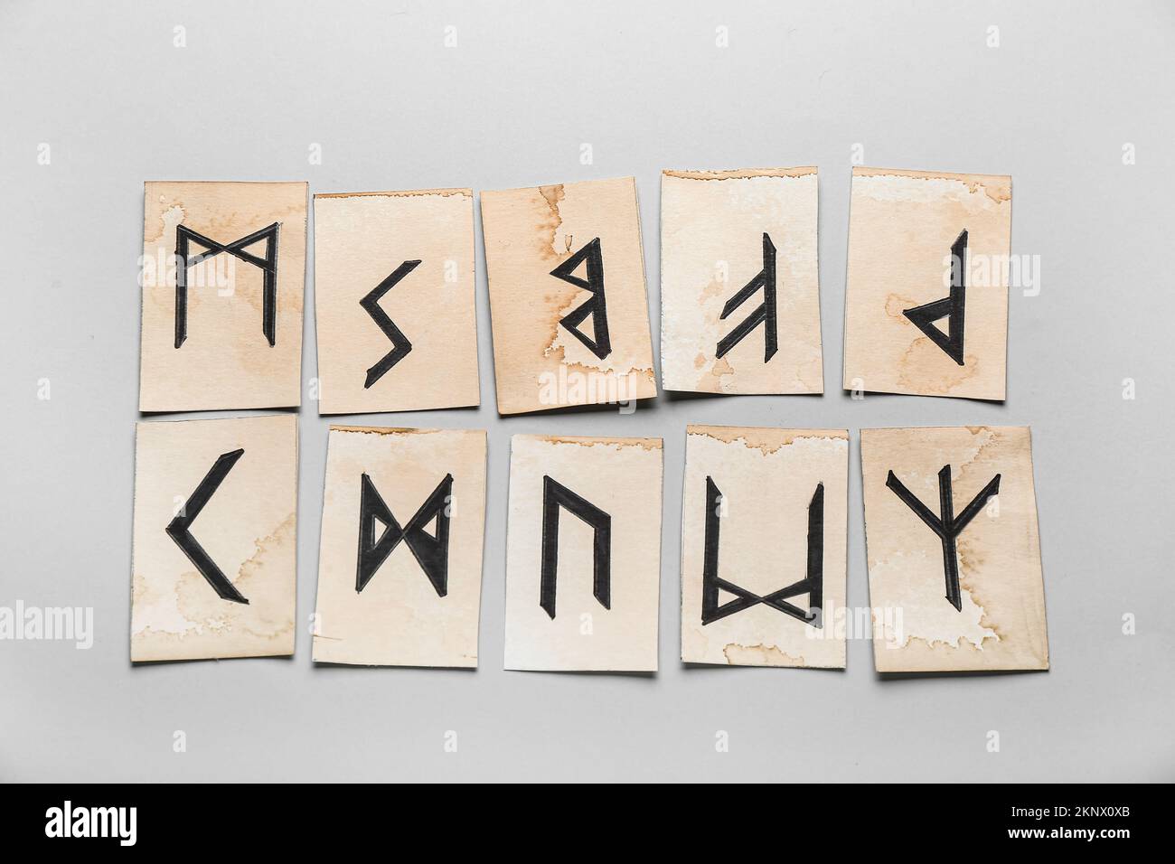 Paper cards with Elder Futhark runes on white background Stock Photo ...