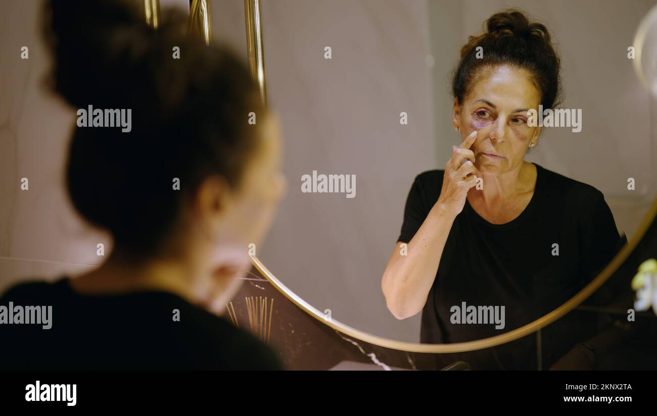 Middle age hispanic woman suffering for domestic violence looking on ...