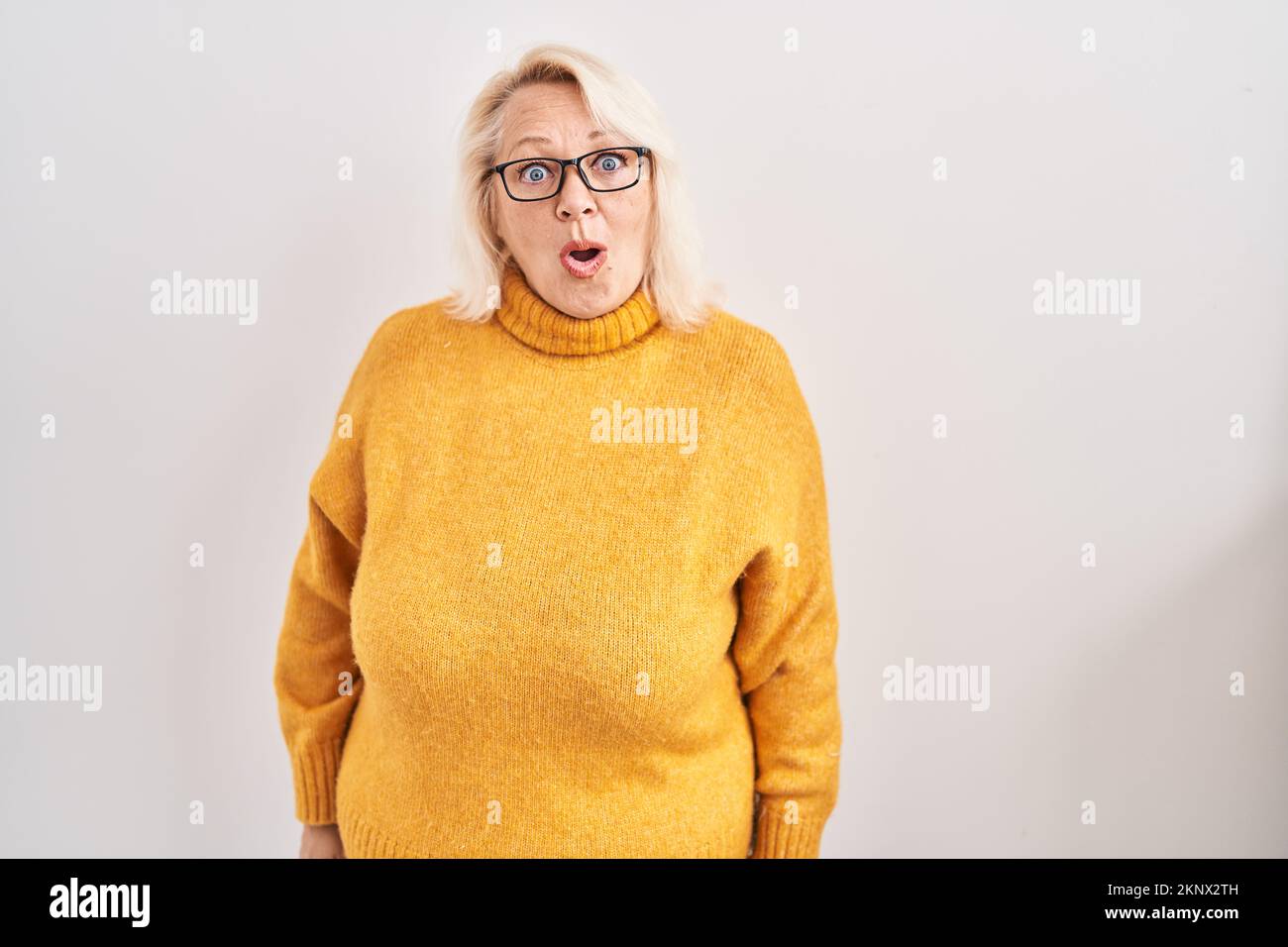 Middle age caucasian woman wearing glasses standing over background ...