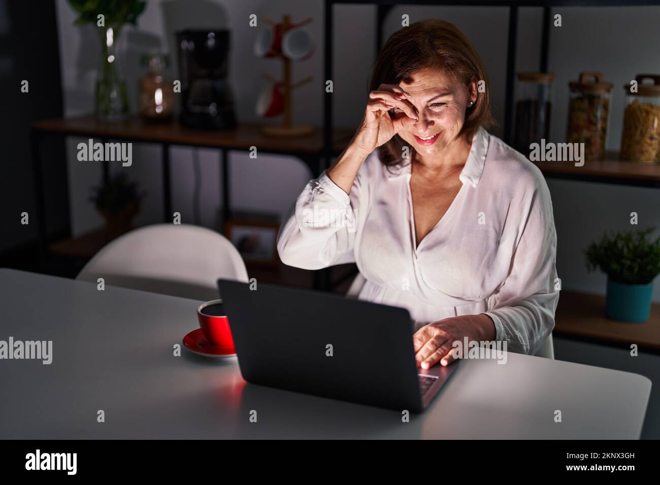 Middle age hispanic woman using laptop at home at night doing ok ...