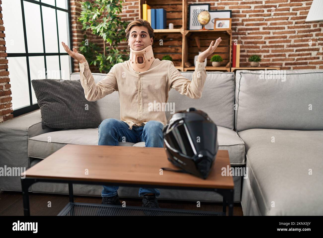 Young man wearing cervical collar for motorbike accident clueless and ...