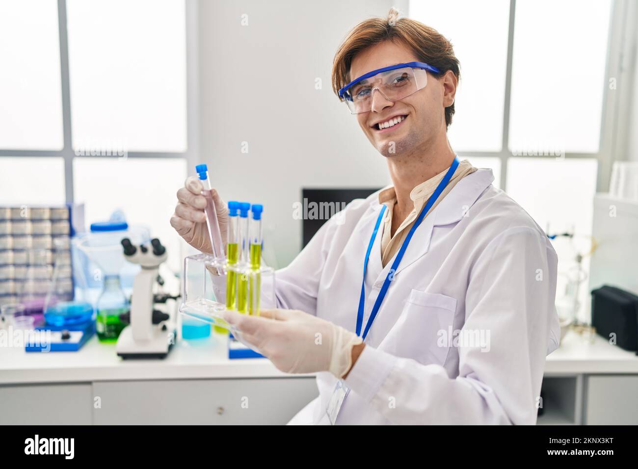 Young caucasian man scientist holding test tubes at laboratory Stock ...