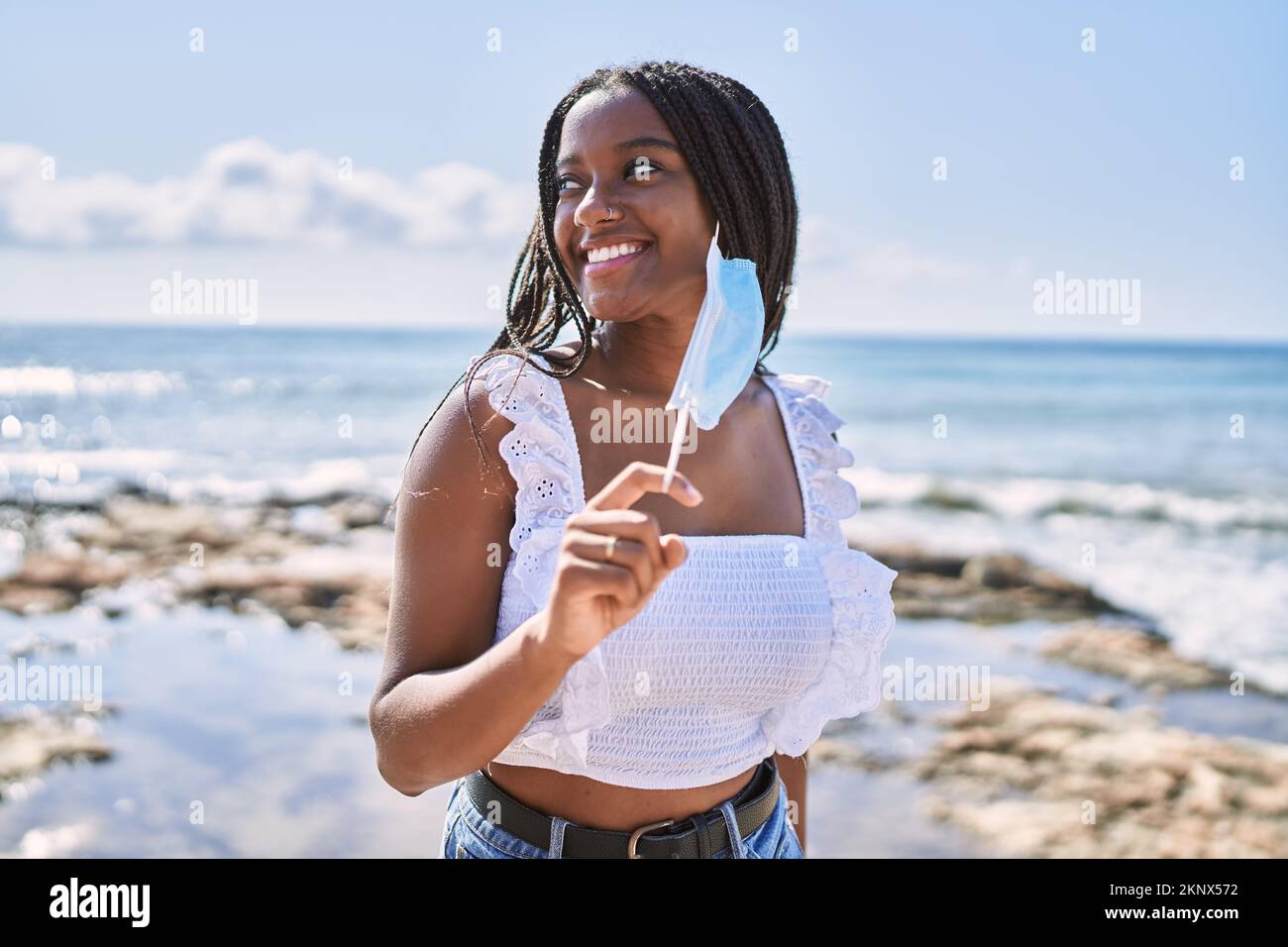 Young african american girl smiling happy plume at the beach Stock ...