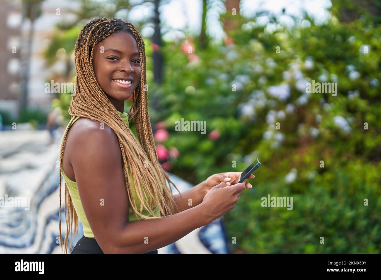 African american woman smiling confident using smartphone at park Stock ...