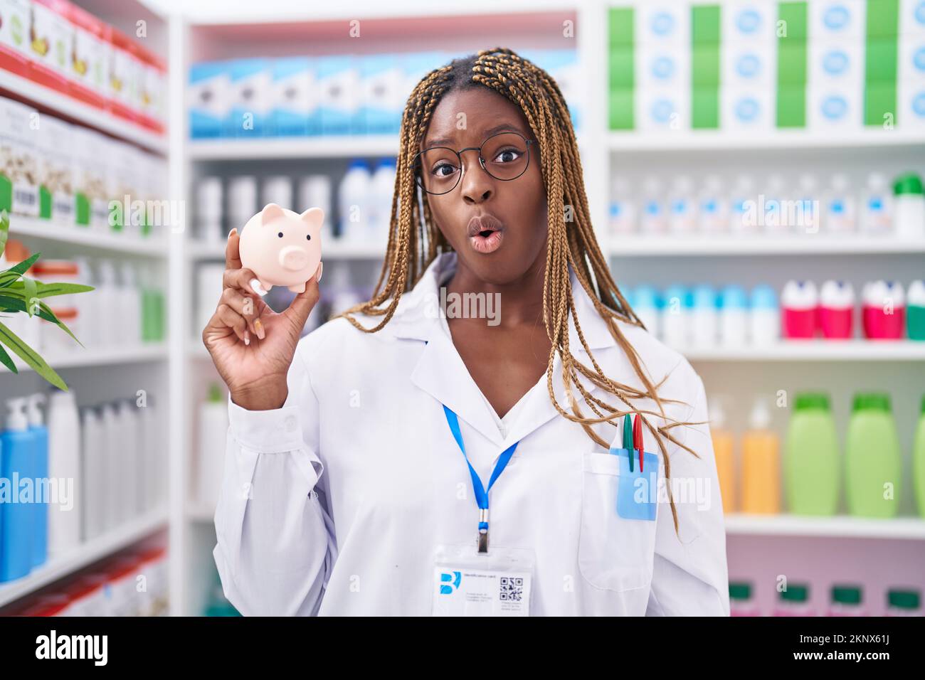 African american woman with braided hair working at pharmacy drugstore ...