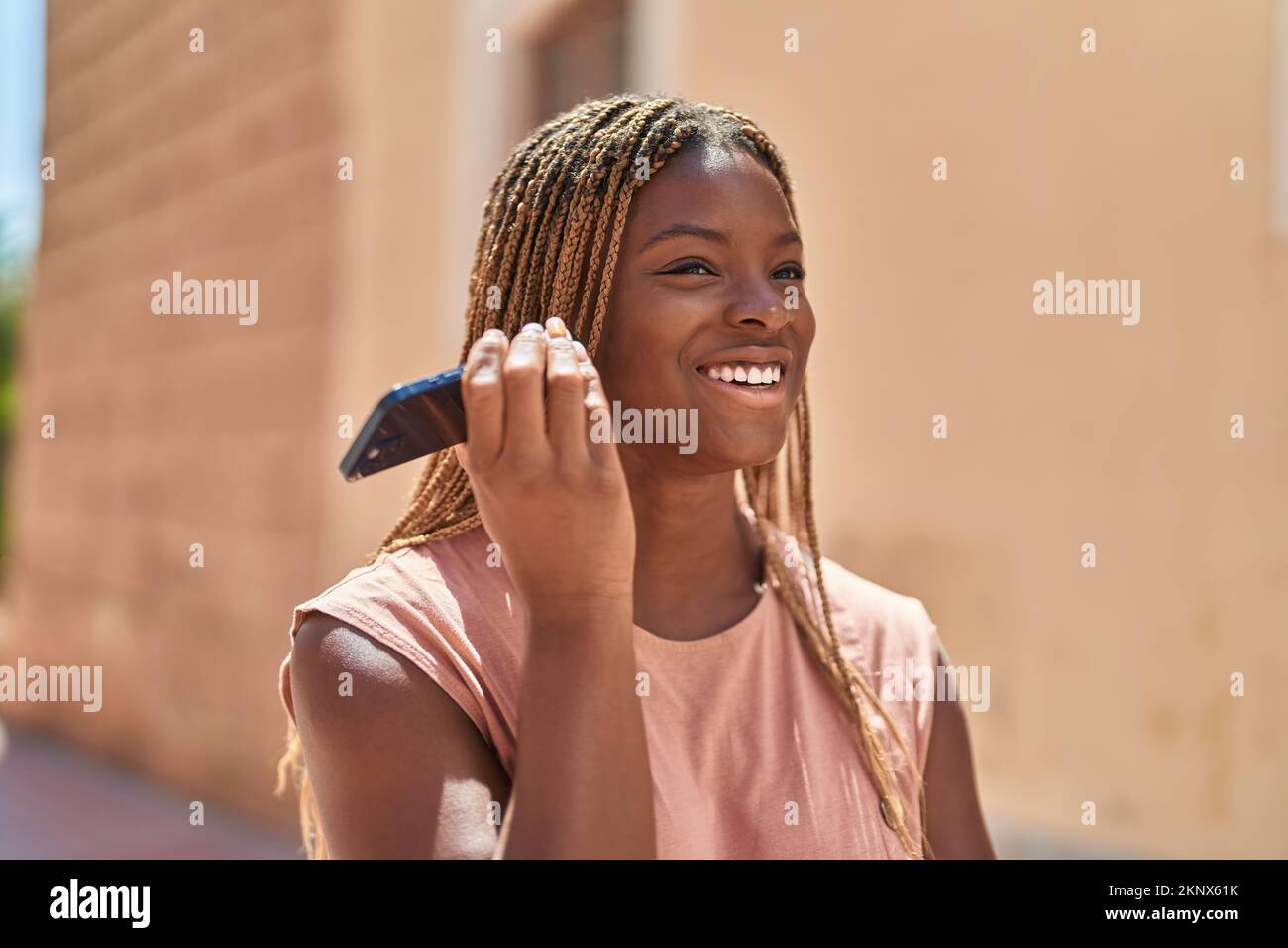 African american woman miling confident listening audio message by the ...